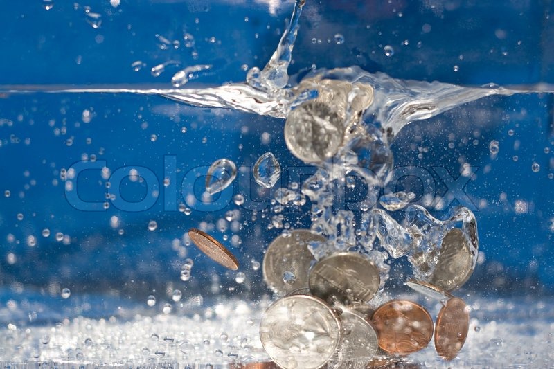A handful of coins dropping into a pool ... | Stock image | Colourbox