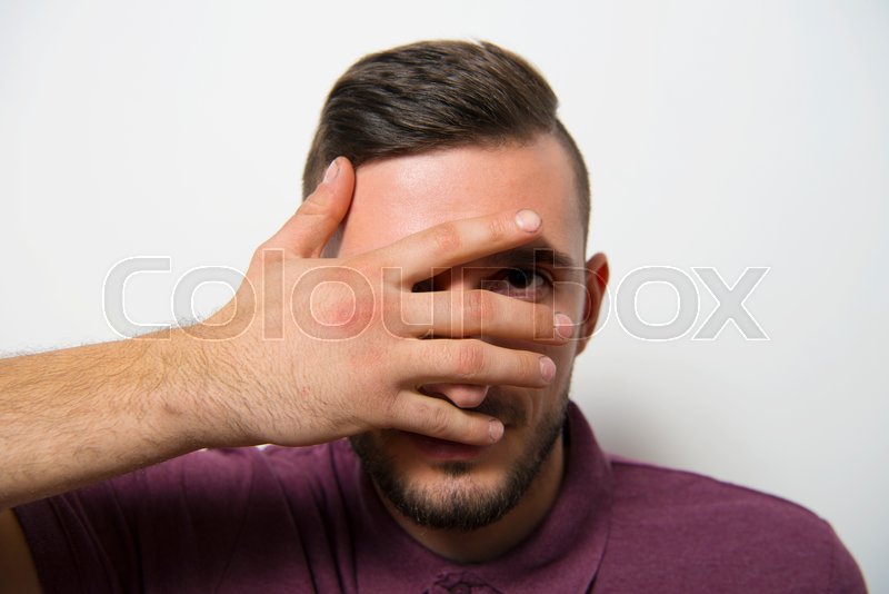 Man closes eyes with her hands | Stock image | Colourbox