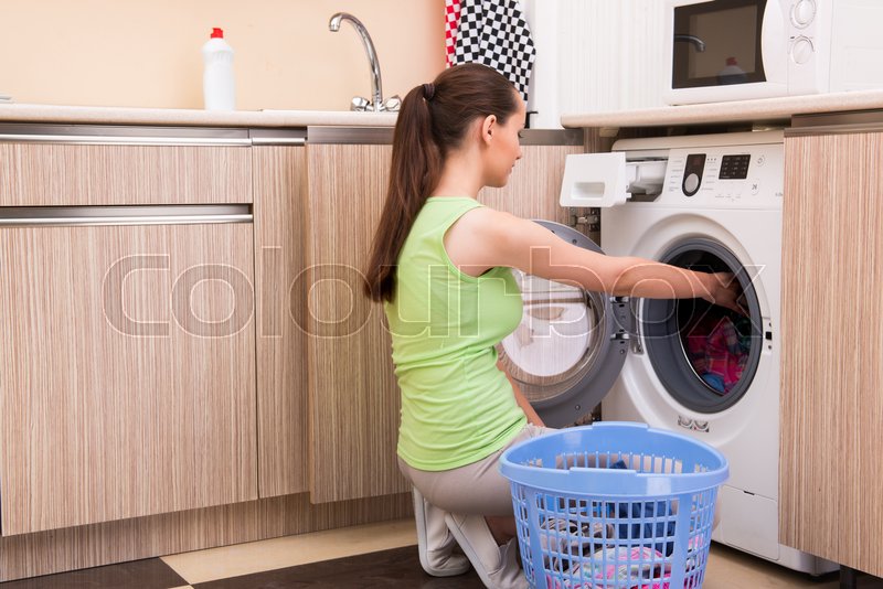Young wife woman washing clothes near ... | Stock Photo | Colourbox