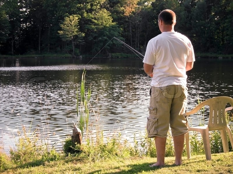 A lone fishermen fishing in a rural ... | Stock image | Colourbox