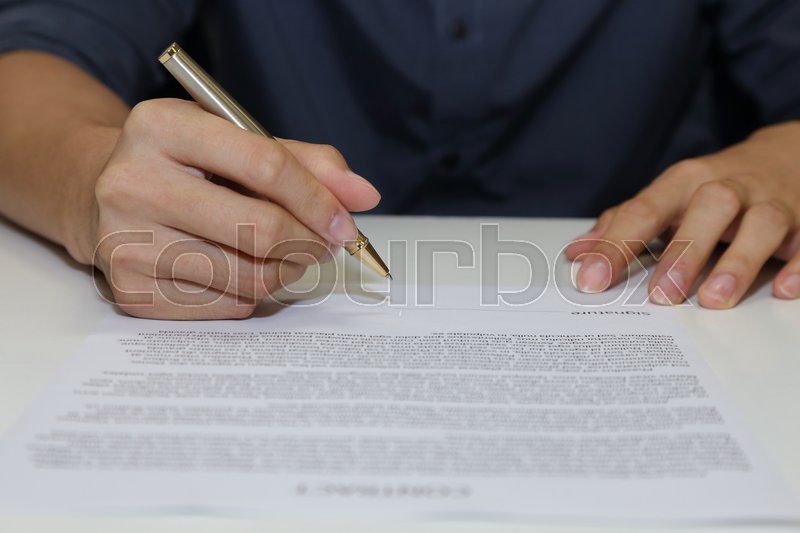 Close-up on a businessman hand signing ... | Stock image | Colourbox
