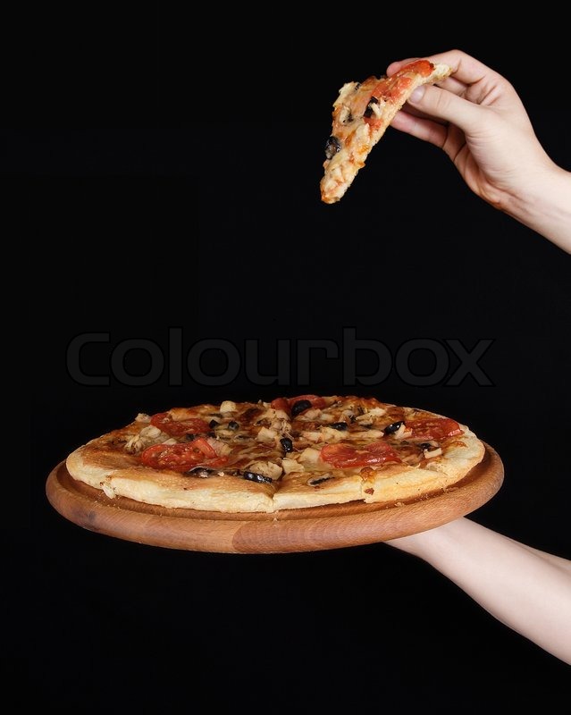 Tasty pizza and hand | Stock image | Colourbox
