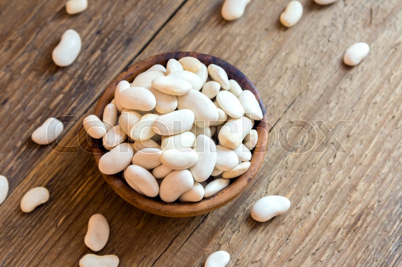 Organic Raw White Beans in wooden bowl ... | Stock image | Colourbox