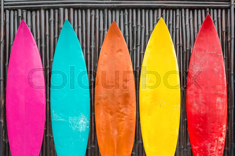 Four colorful surfboards on the wooden ... | Stock image | Colourbox