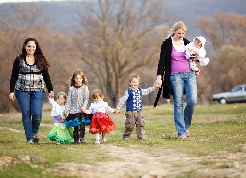 Group of kids with parents walking ... | Stock image | Colourbox