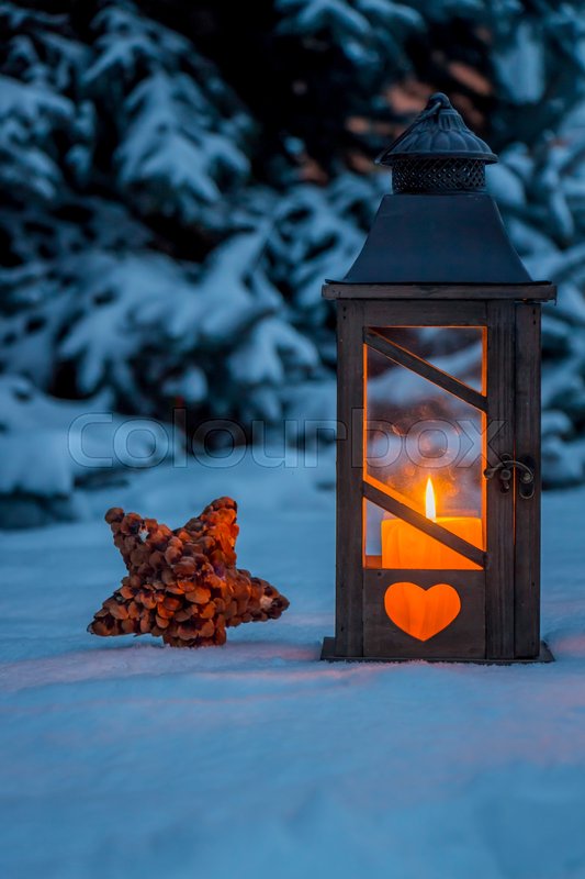 A lantern lights up the snow at ... | Stock image | Colourbox