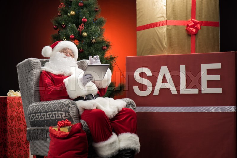 Santa Claus sitting on grey armchair ... | Stock image | Colourbox