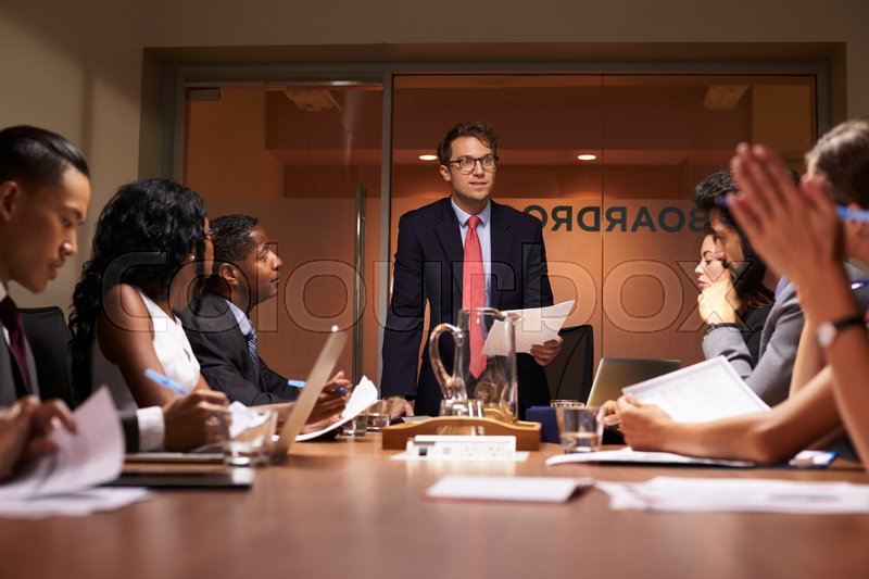Businessman stands addressing team at ... | Stock image | Colourbox