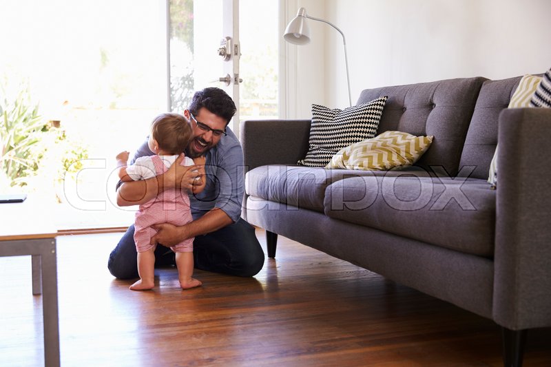 Father Watching Baby Daughter Take ... | Stock image | Colourbox