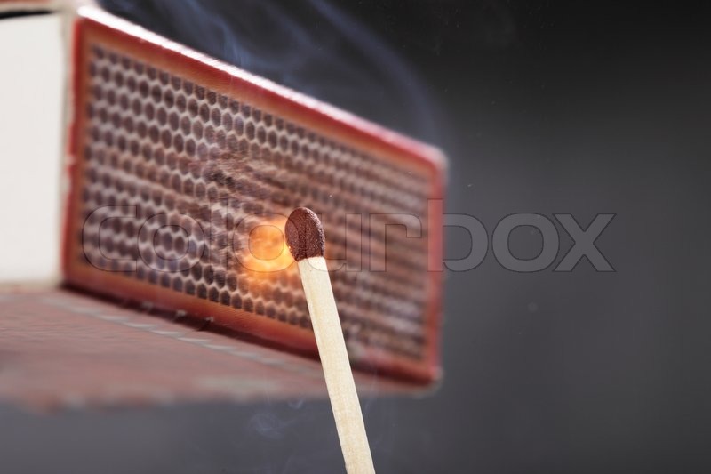 A Match ignited by rubbing the match head against a match box | Stock ...