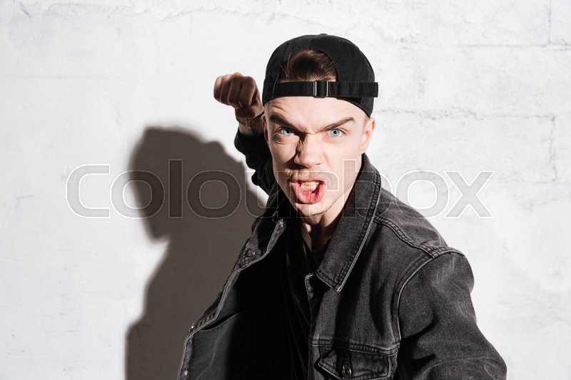 Angry Hipster in snap back wants to hit ... | Stock image | Colourbox