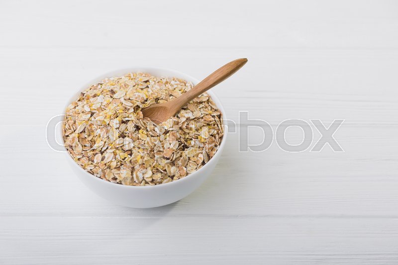 Uncooked grain of oatmeal in white ... | Stock image | Colourbox