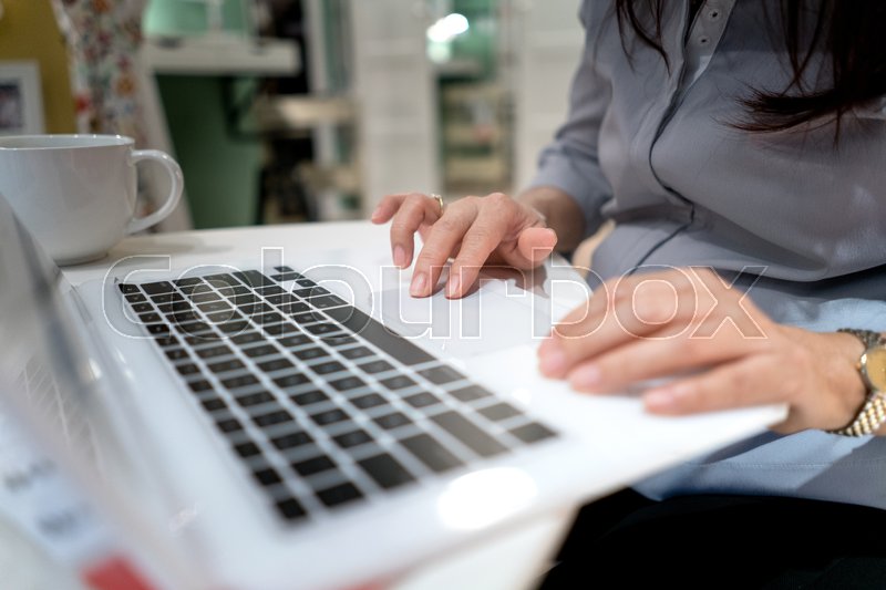 Close up woman hands using laptops in ... | Stock image | Colourbox