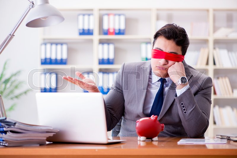 Blindfold businessman sitting at desk ... | Stock image | Colourbox