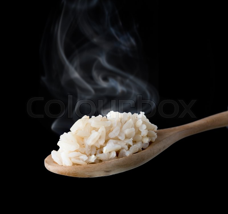 Cooked brown rice in a wooden spoon ... | Stock image | Colourbox