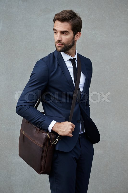Seriously suited man with bag | Stock image | Colourbox