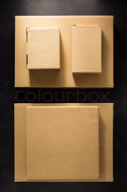 Cardboard box on black background ... | Stock image | Colourbox