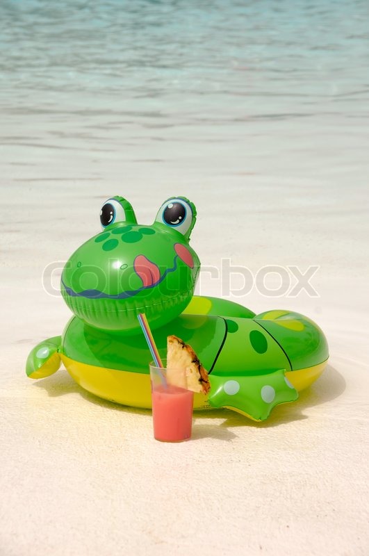 Happy frog is enjoying a cool drink by ... | Stock image | Colourbox