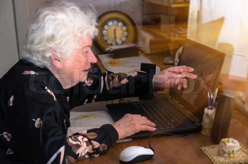 Grandmother learns to work at home on ... | Stock image | Colourbox