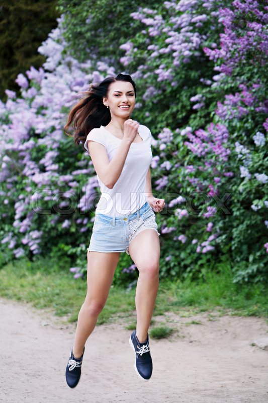 Young beautiful woman jogging in spring ... | Stock image | Colourbox