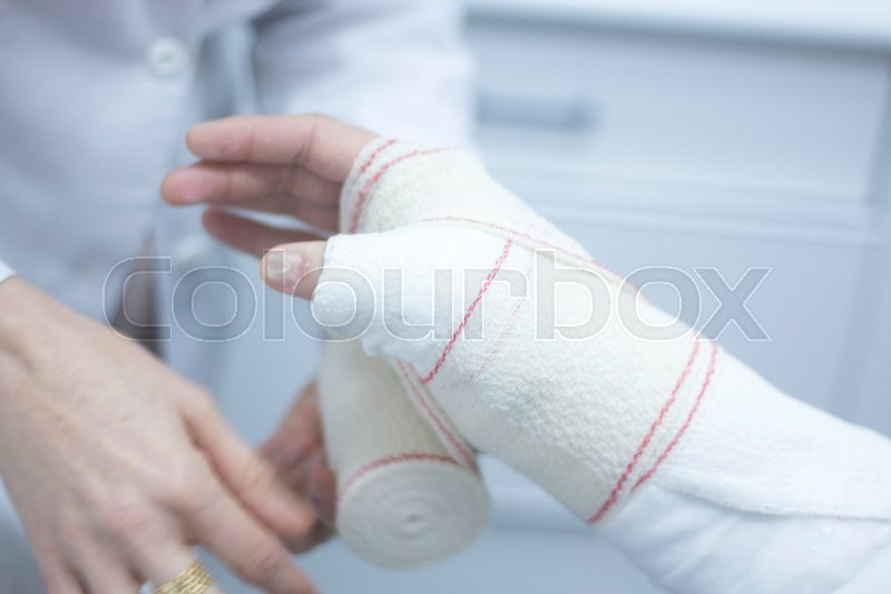 Doctor applying a plaster cast and ... | Stock image | Colourbox