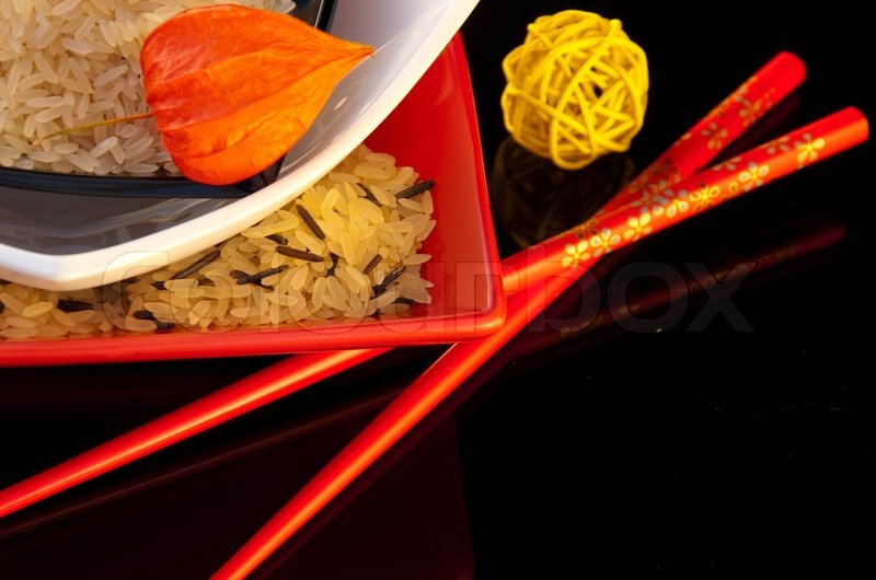 Rice in multi-colored plates and red ... | Stock image | Colourbox