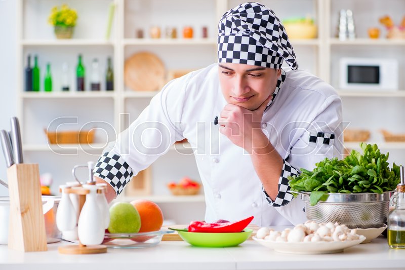 Young male cook working in the kitchen | Stock image | Colourbox