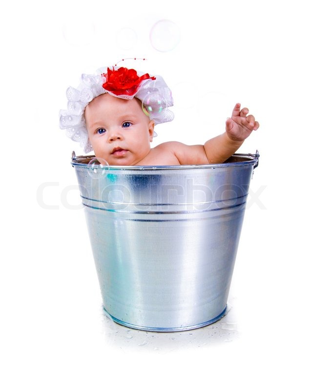 Little baby on a bucket on white ... | Stock image | Colourbox