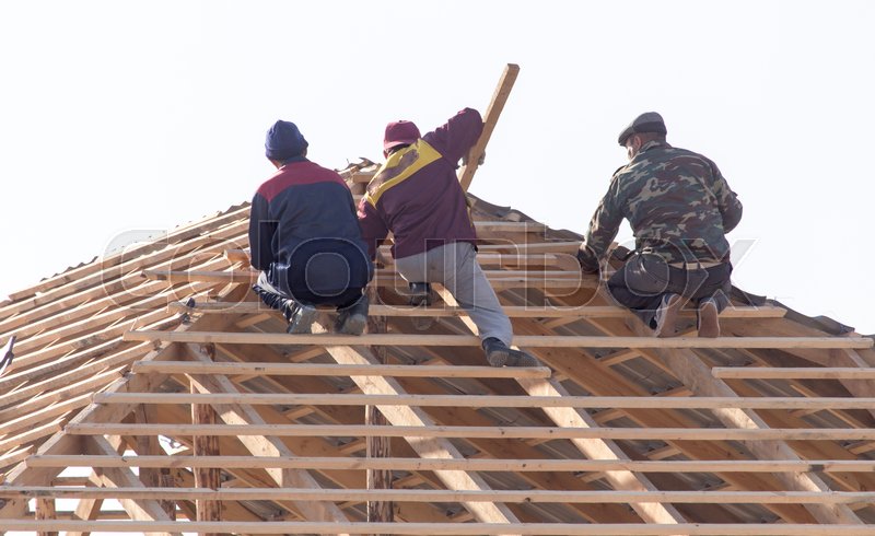 Workers working on the roof . A photo | Stock image | Colourbox
