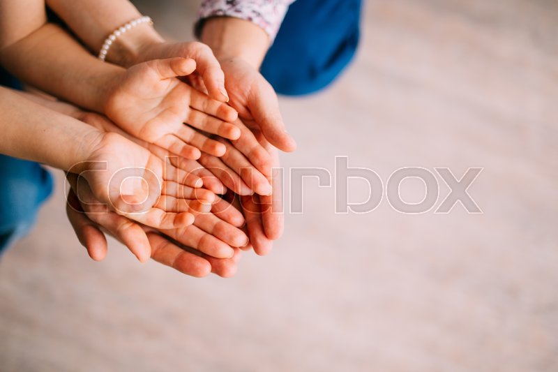Children's hands in the hands of ... | Stock image | Colourbox