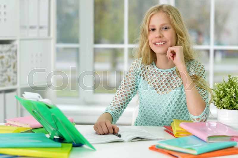 Portrait of a cute girl does lessons | Stock image | Colourbox
