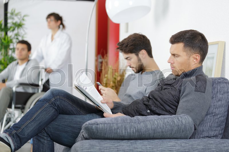 Men sat on settee, patient being ... | Stock image | Colourbox