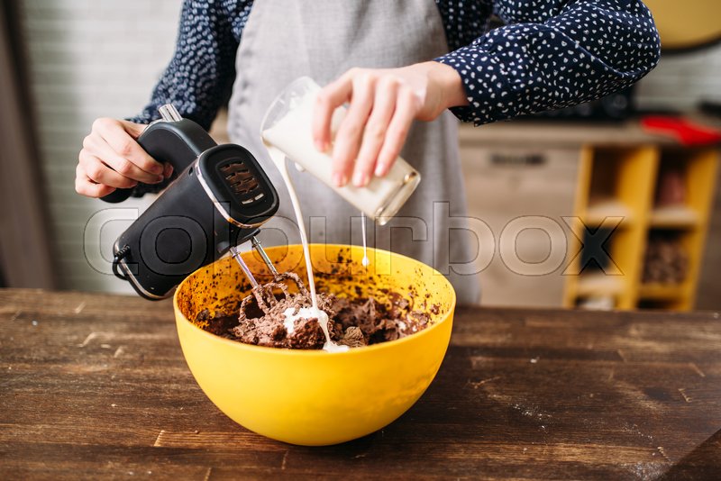 Person Mixing Ingredients In A Bowl