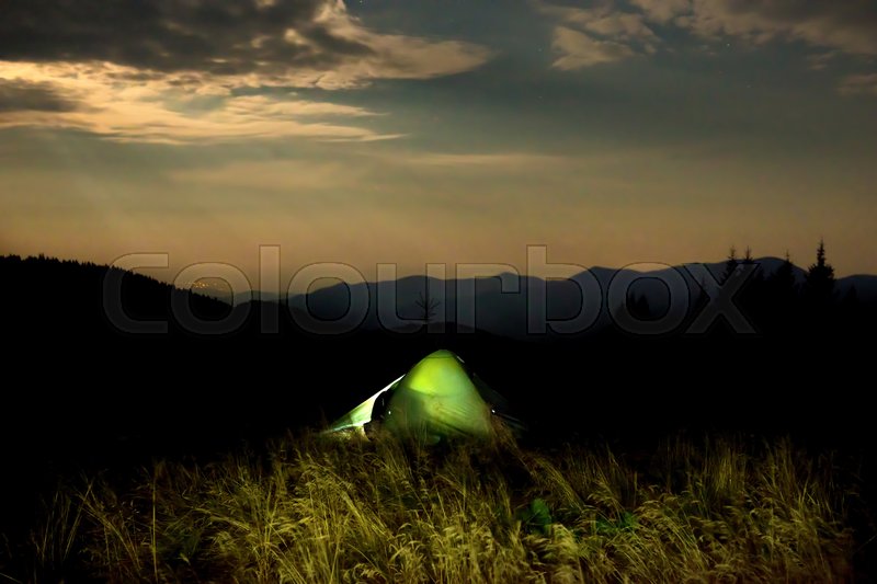 Illuminated green camping tent on a ... | Stock image | Colourbox