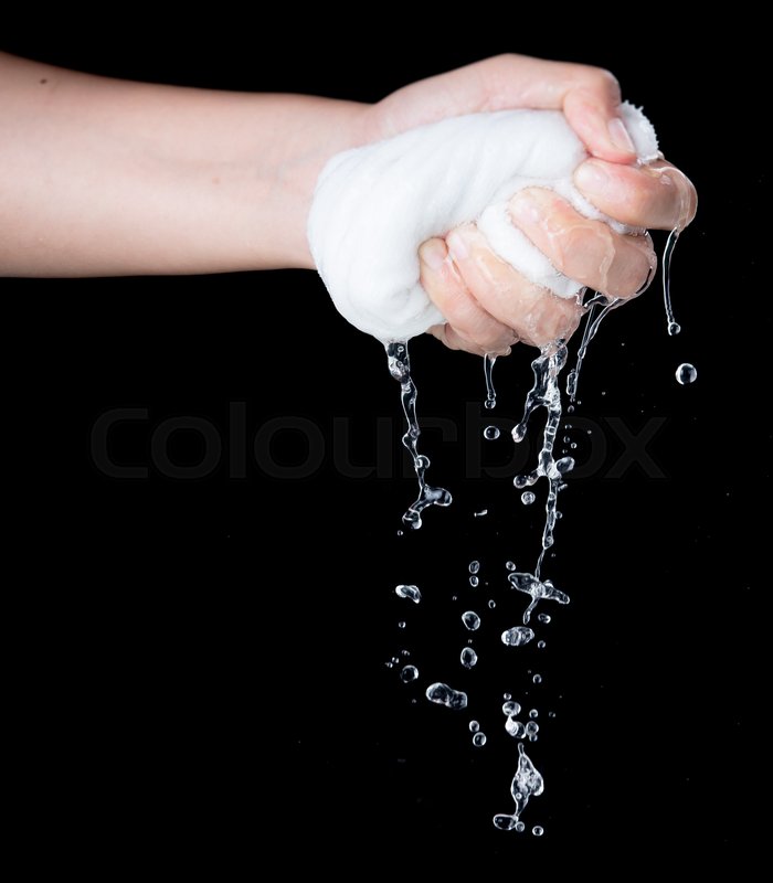 Hand squeeze wet fabric over dark ... | Stock image | Colourbox
