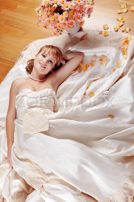 Portrait of beautiful bride lying on ... | Stock image | Colourbox