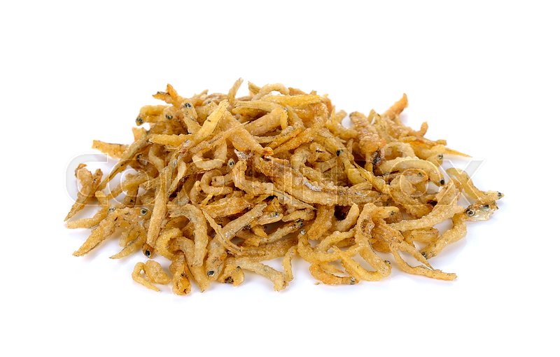 Tiny dried fish isolated on white ... | Stock image | Colourbox