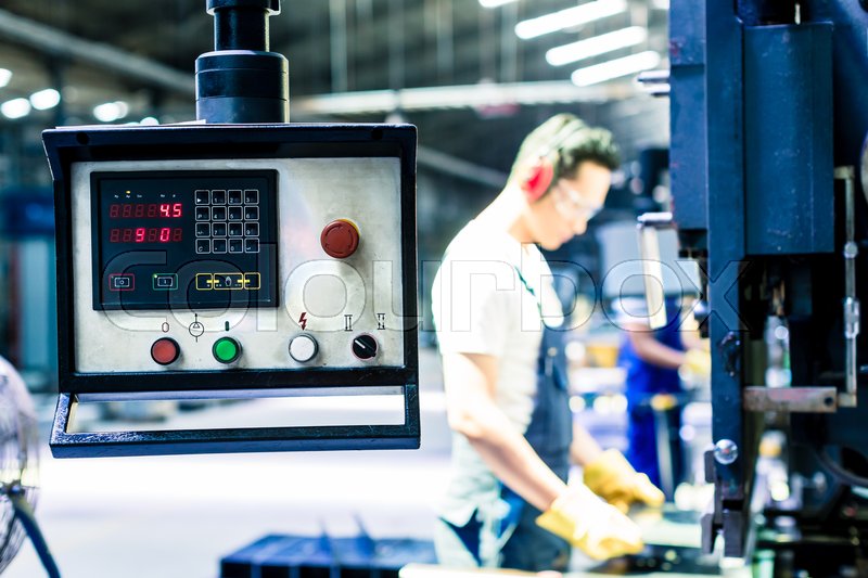 Asian machine operator in production ... | Stock image | Colourbox