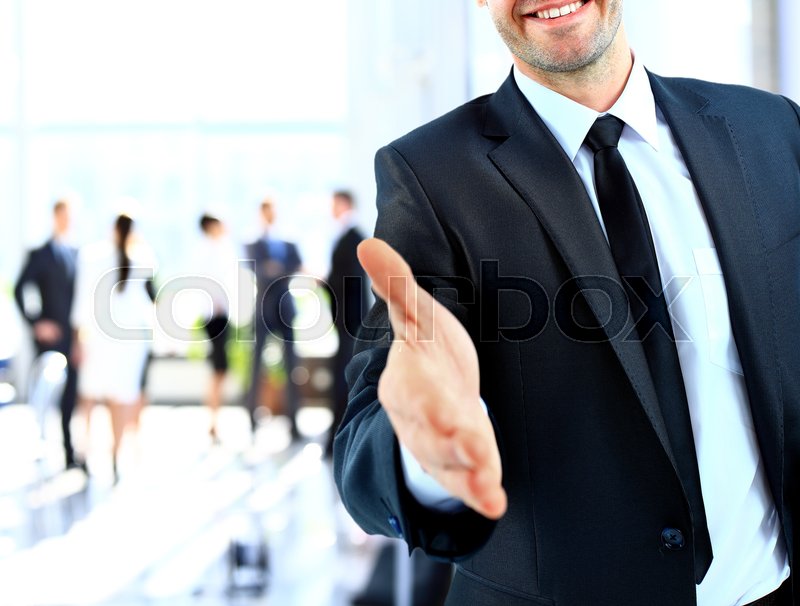 Business man saying welcome and giving ... | Stock image | Colourbox