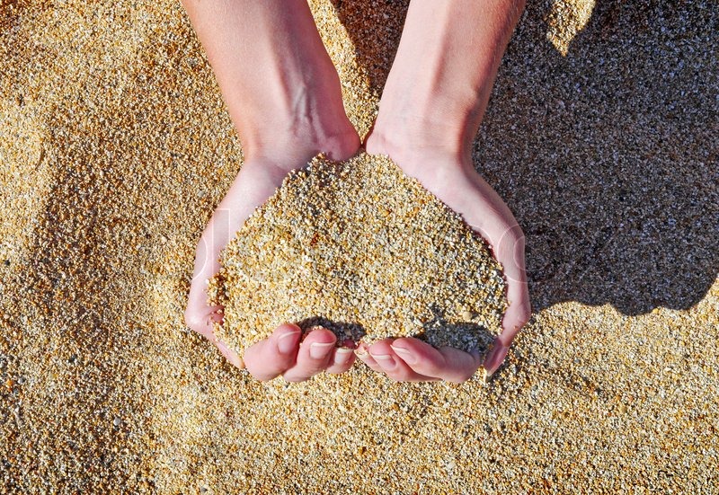 A woman's hand holding the sand | Stock image | Colourbox