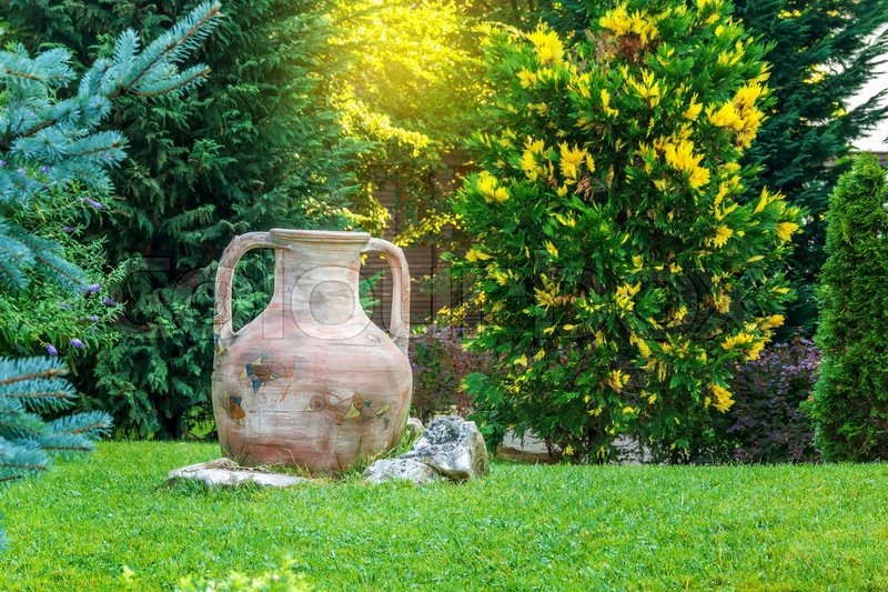 Beautiful ancient amphora in garden in ... | Stock image | Colourbox