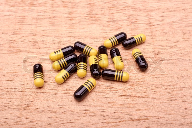 Capsules or pills yellow and black of ... | Stock image | Colourbox