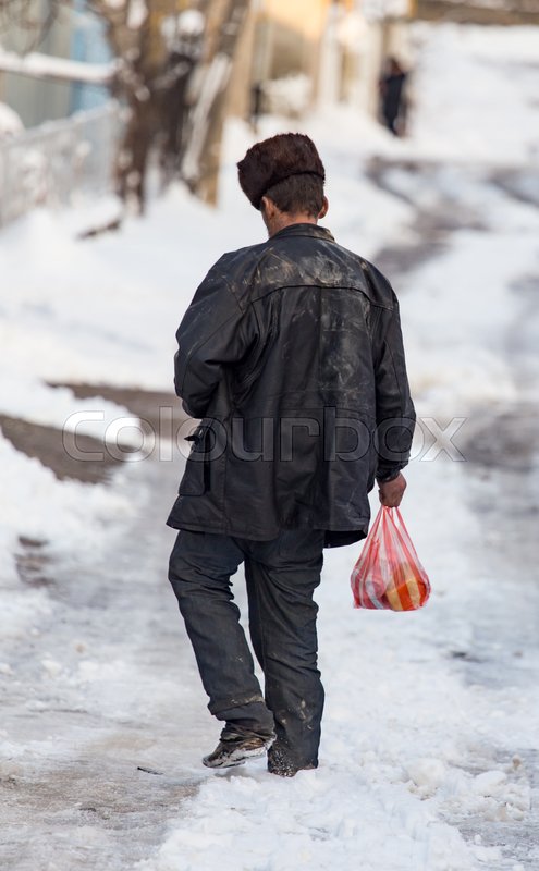 Homeless man is walking on the road in ... | Stock image | Colourbox