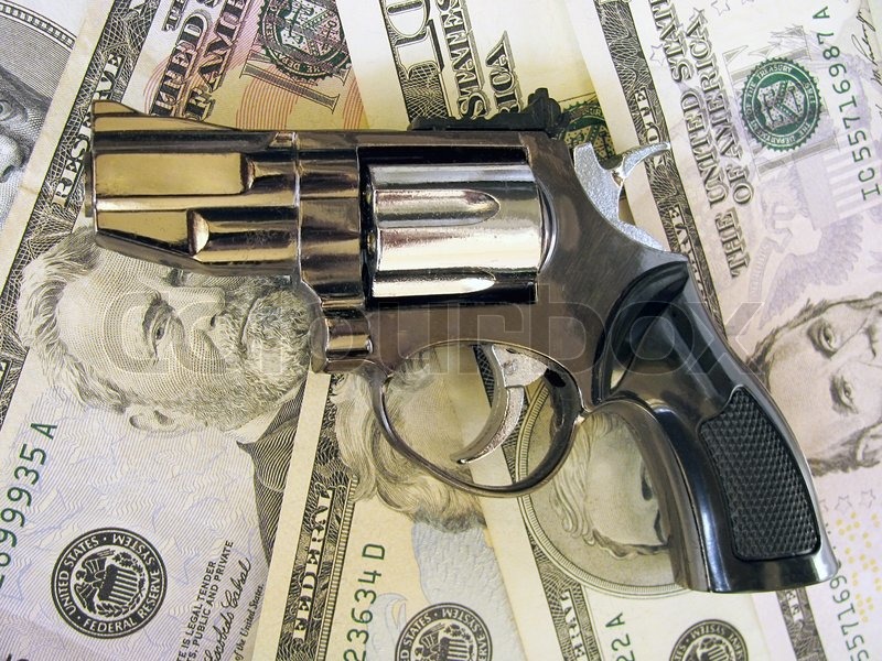 Gun lying on cash (heap of dollars ... | Stock image | Colourbox