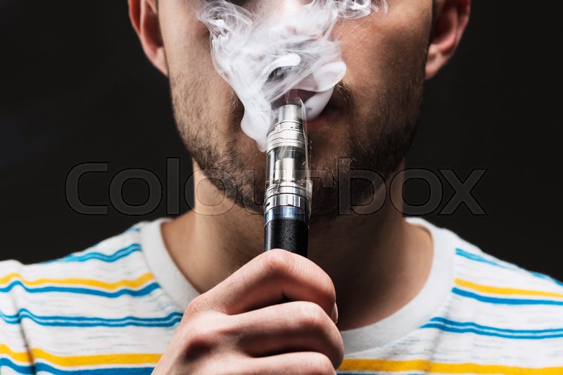 The face of vaping young man on black ... | Stock image | Colourbox