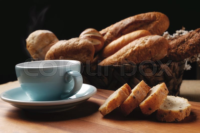 Fresh bread and a cup of coffee on the ... | Stock image | Colourbox