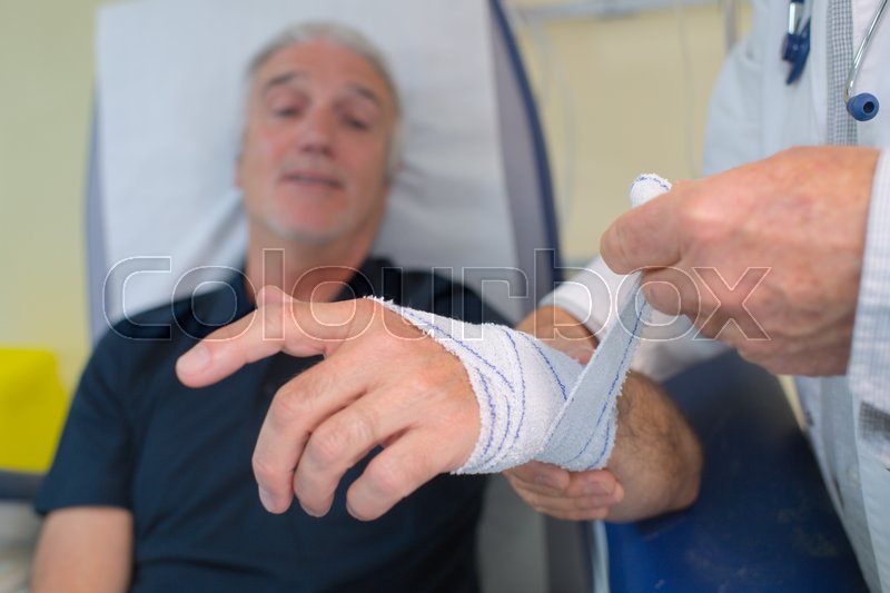 Nurse applying bandage to patient ... | Stock image | Colourbox