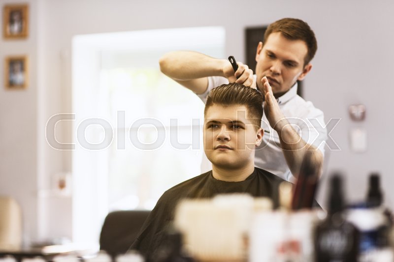 Professional barber in a barbershop ... | Stock image | Colourbox