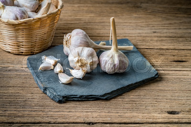 Image of Garlic on black stone plate | Stock image | Colourbox