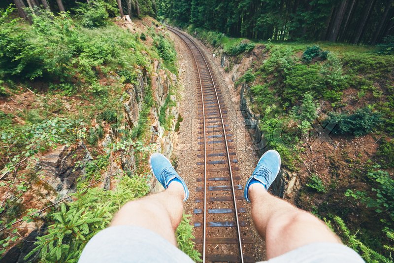 Man sitting above railroad track in the ... | Stock image | Colourbox
